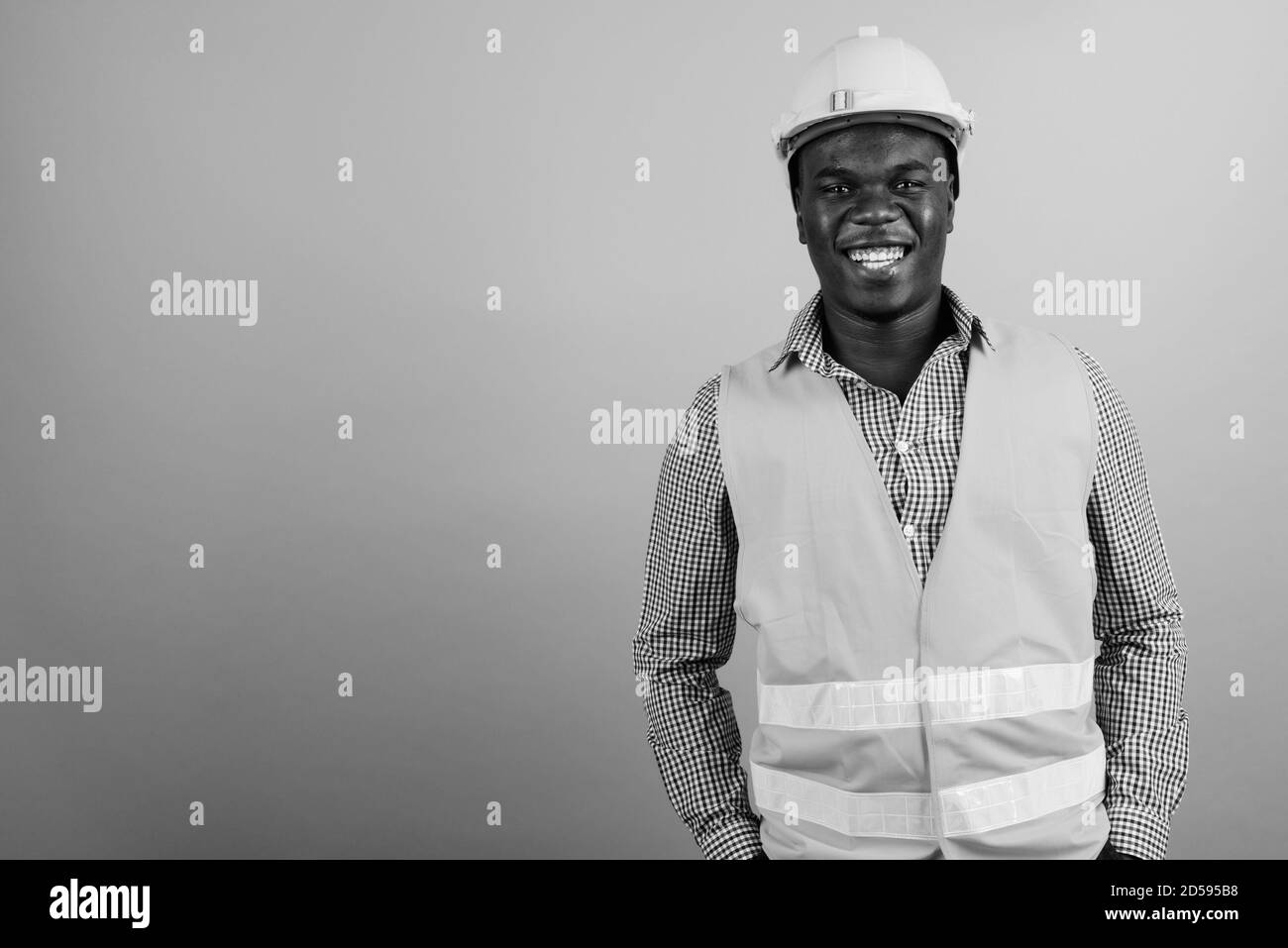 Happy young African man construction worker against white background ...