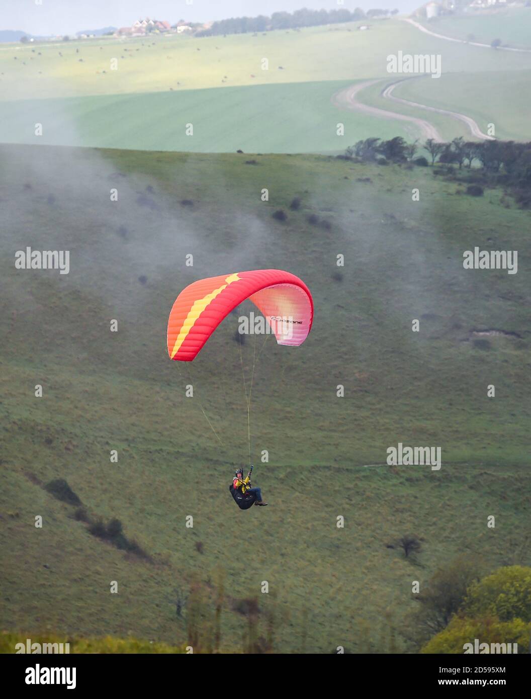 Brighton UK 13th October 2020 - Paragliders rise above the morning ...