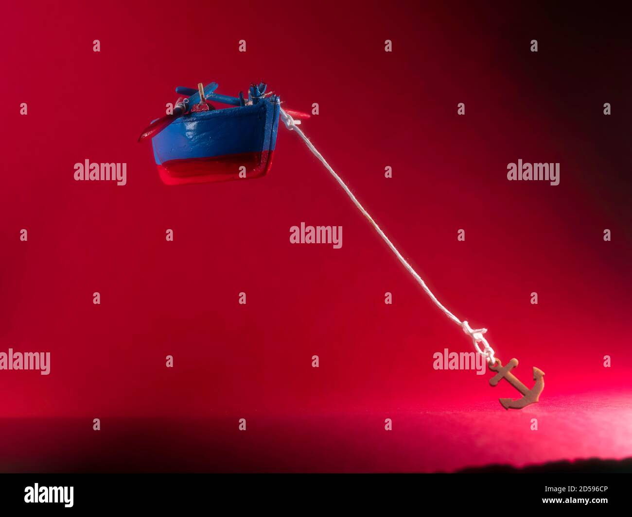 Conceptual rowing boat floating mid air while dropping anchor Stock ...