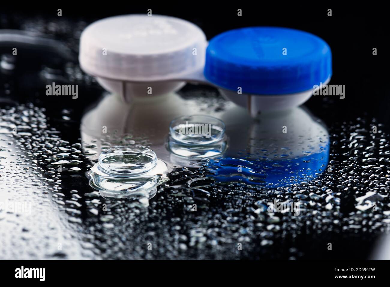Container for contact lenses on wet black background Stock Photo - Alamy