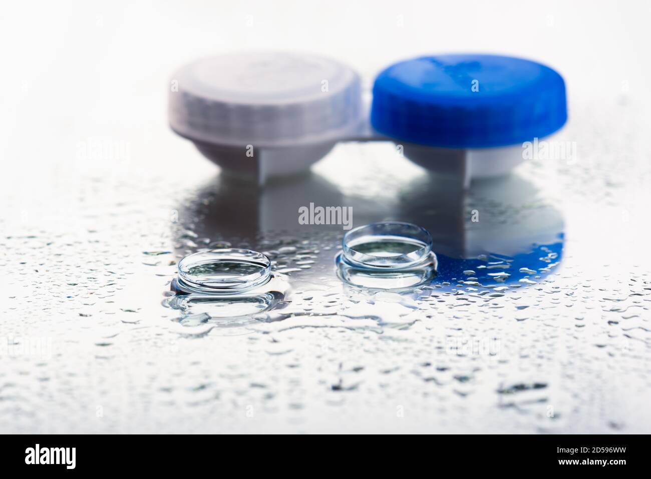 Container for contact lenses on wet white background Stock Photo - Alamy