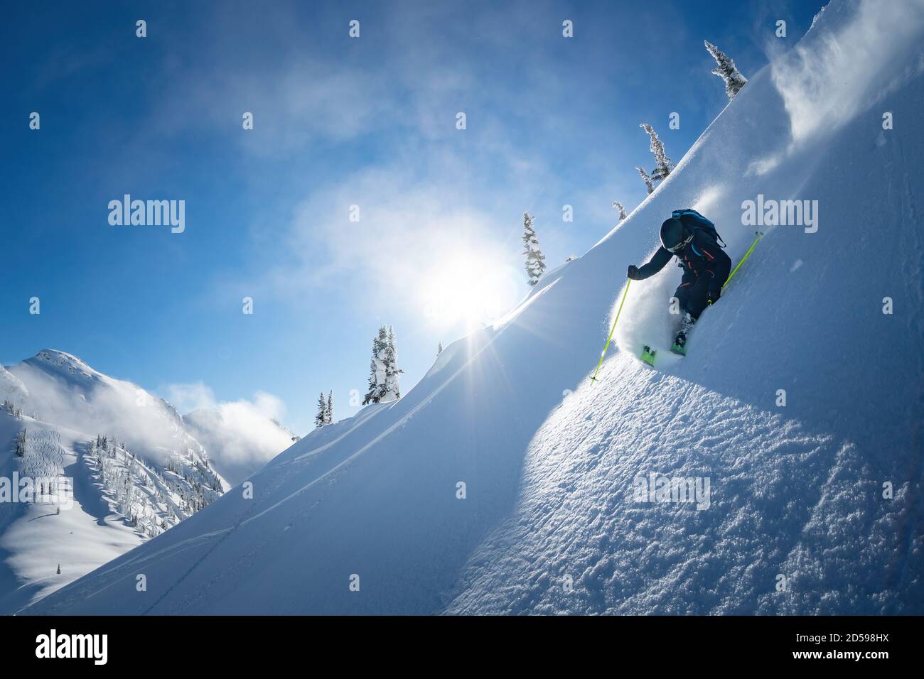 Woman skiing in deep powder snow in the backcountry, Kootenays, British ...