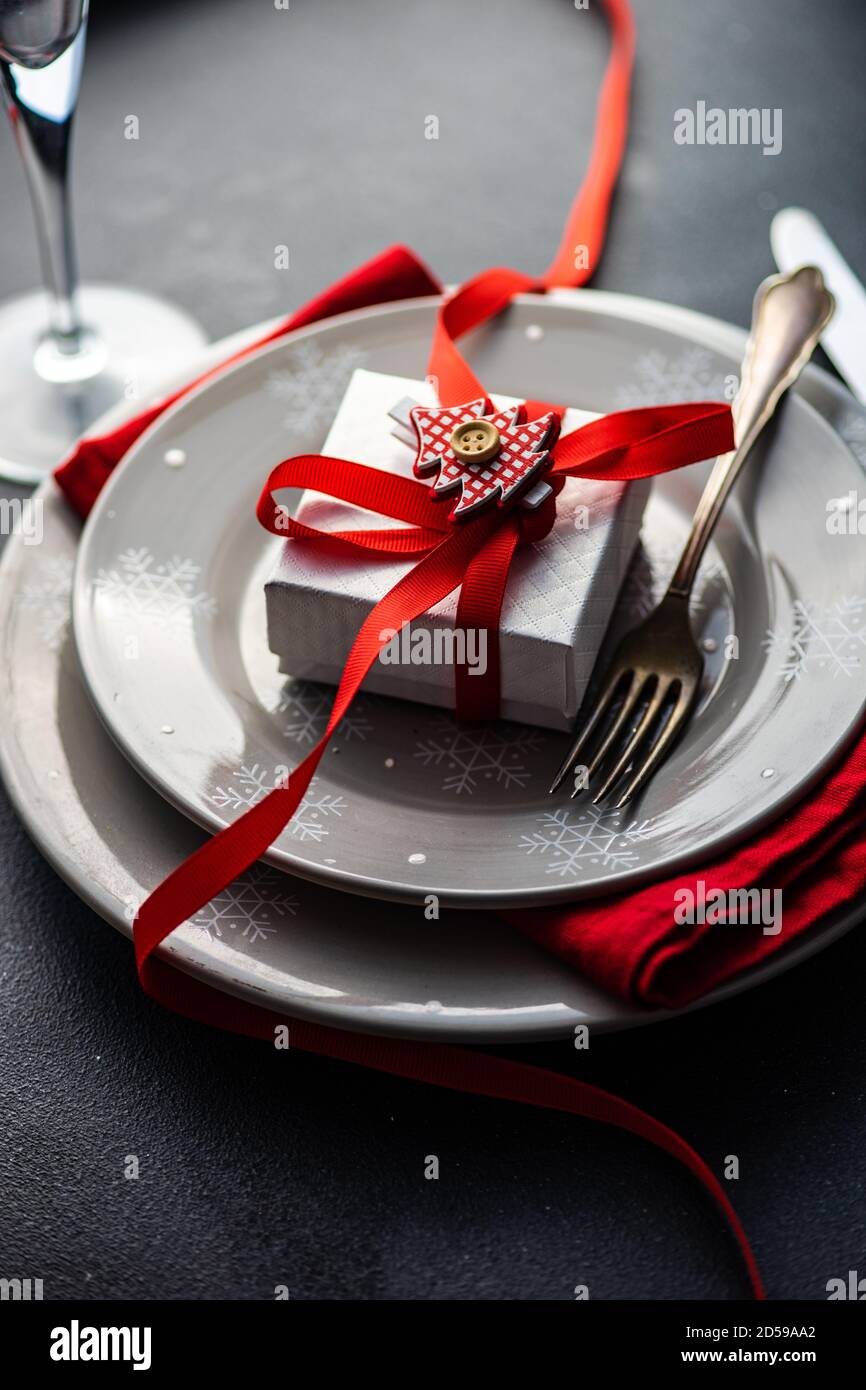 Gift box on a place setting at Christmas Stock Photo - Alamy