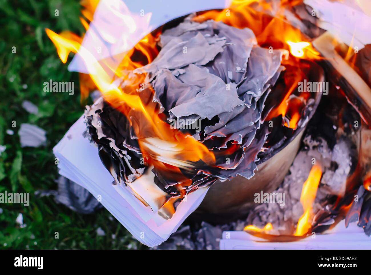 Paper burning on green summer grass outdoors Stock Photo - Alamy