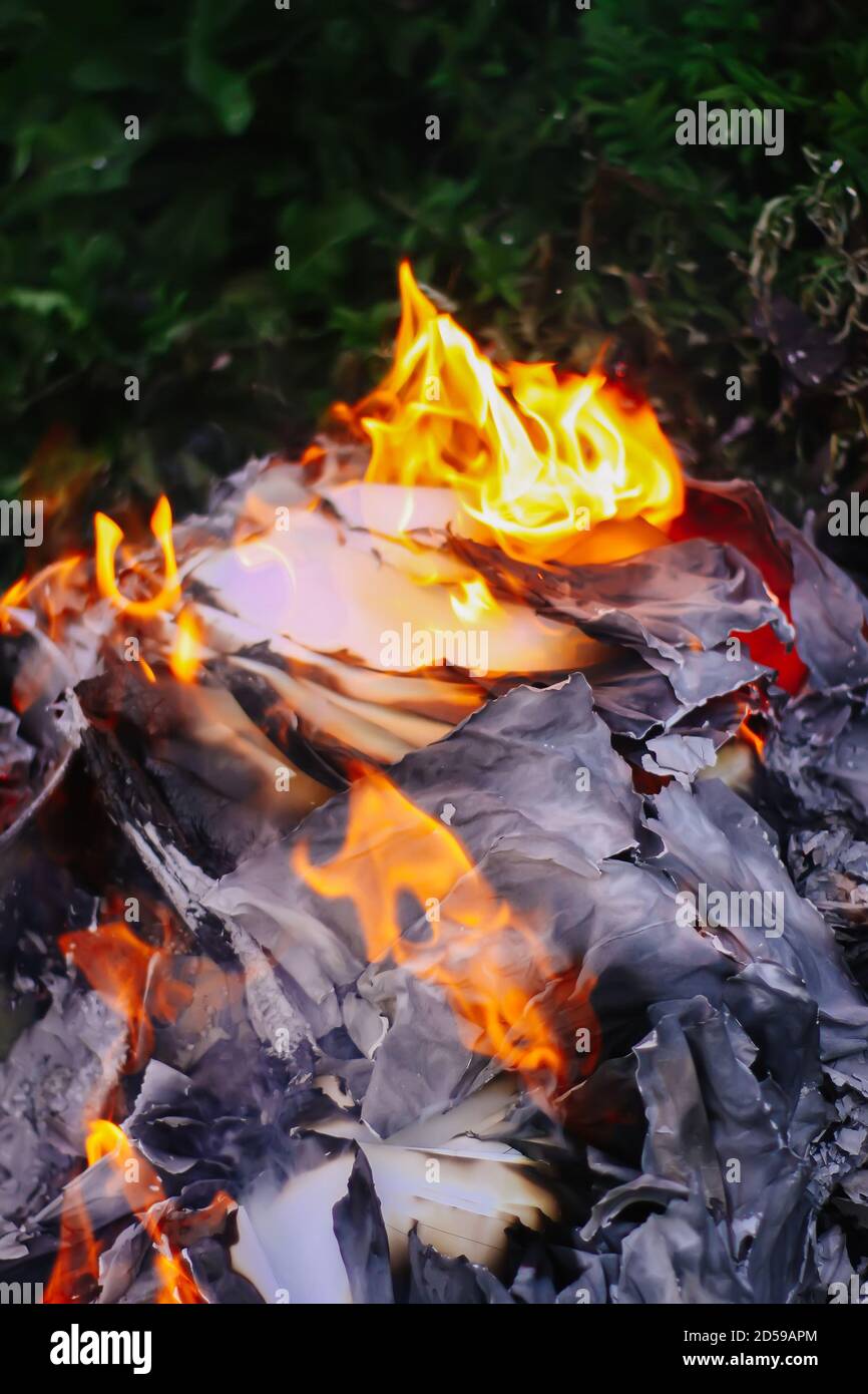 Paper burning on green summer grass outdoors Stock Photo - Alamy