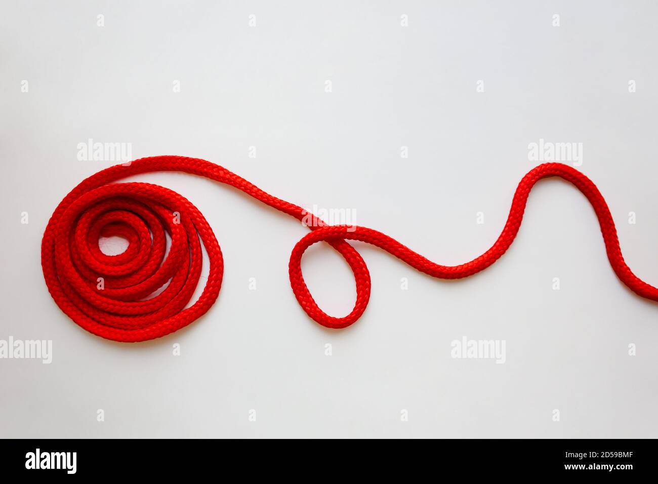 Red textured cord roll with curved line isolated on white background ...