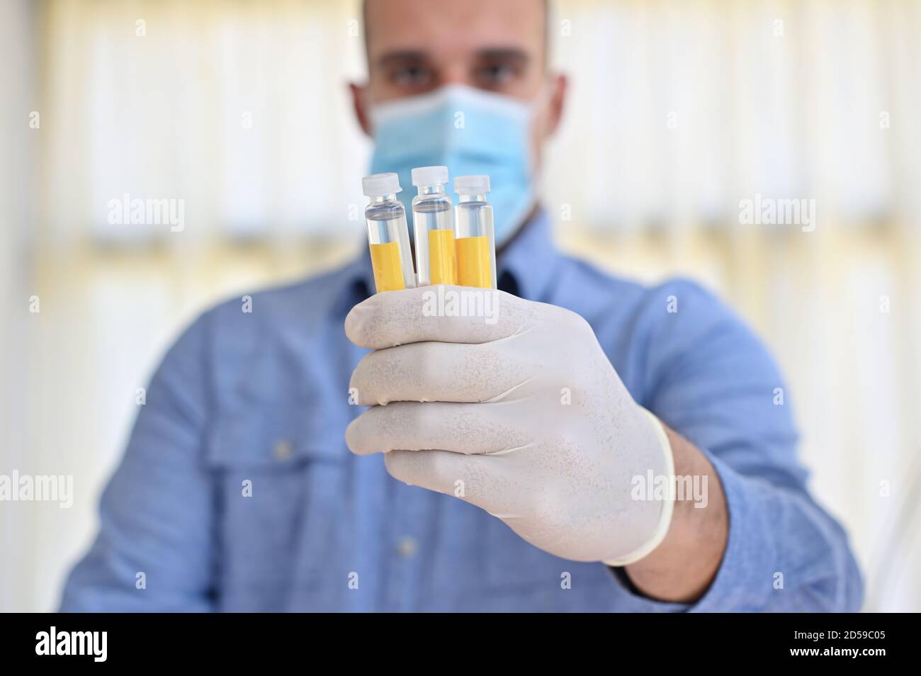 Portrait of a doctor holding three laboratory samples Stock Photo - Alamy