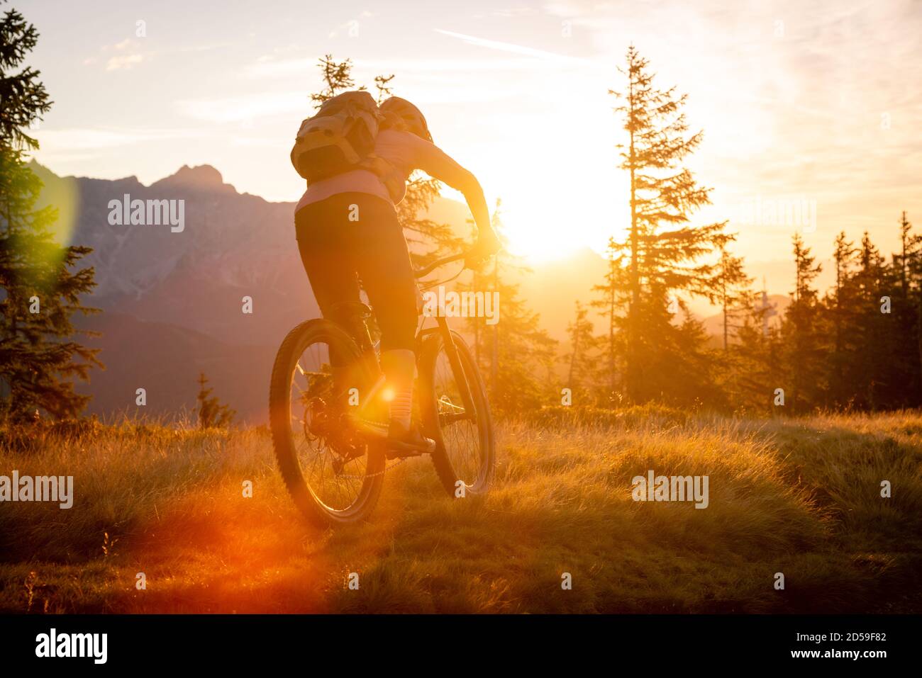 Woman bike sunrise hi-res stock photography and images - Alamy