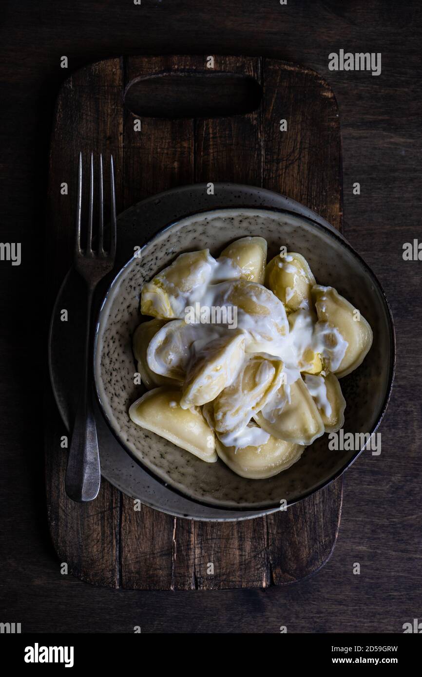 Traditional Ukrainian vareniki potato dumplings with sour cream Stock ...