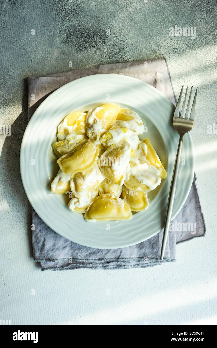 Traditional Ukrainian vareniki potato dumplings with sour cream Stock ...