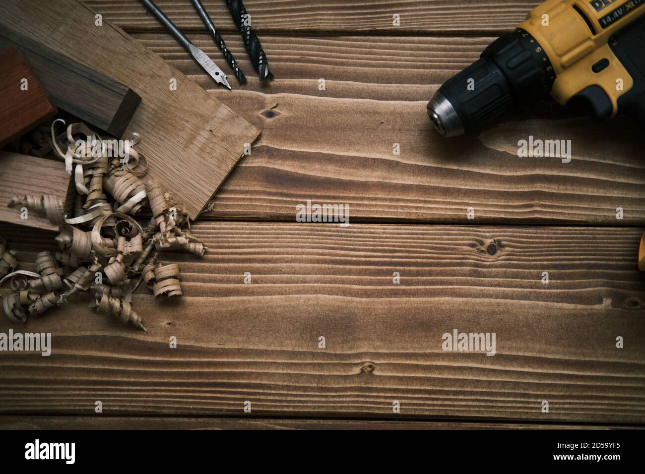 Top view layout of screwdriver with different drills on the wooden ...