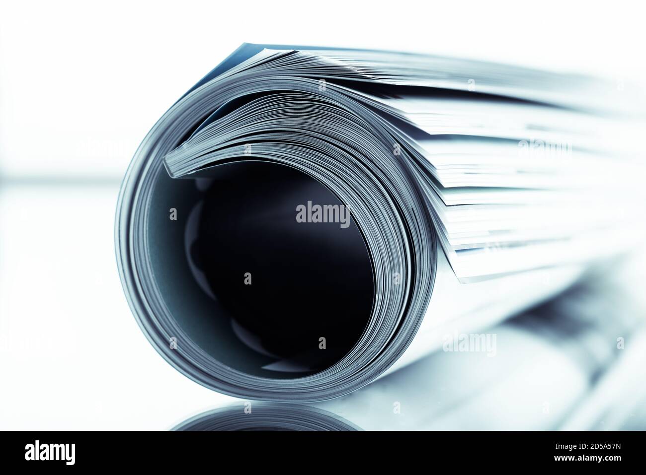 magazine roll on white background Stock Photo - Alamy