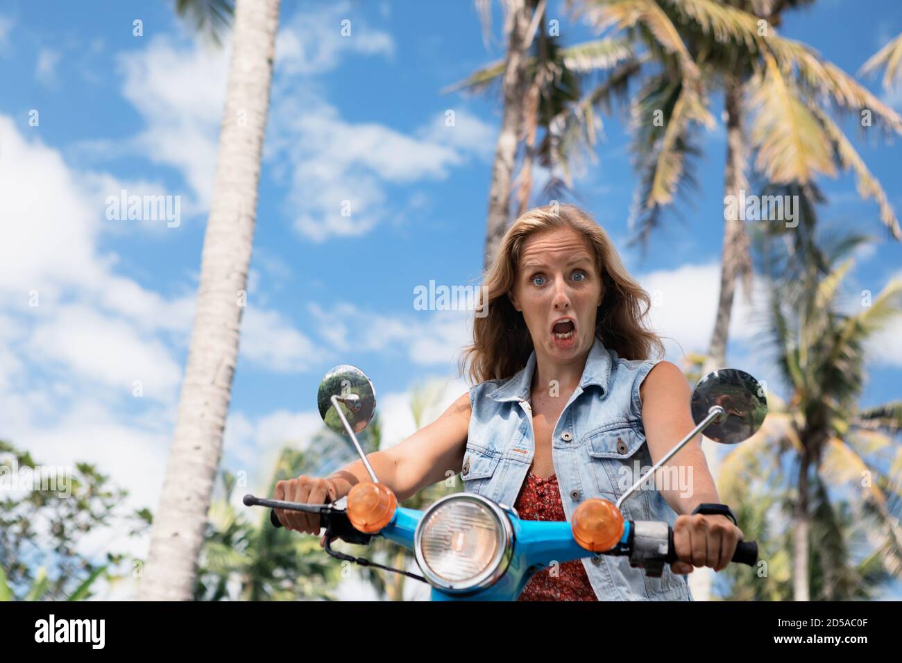 Face portrait of young woman cry frightened. Girl riding on rental ...