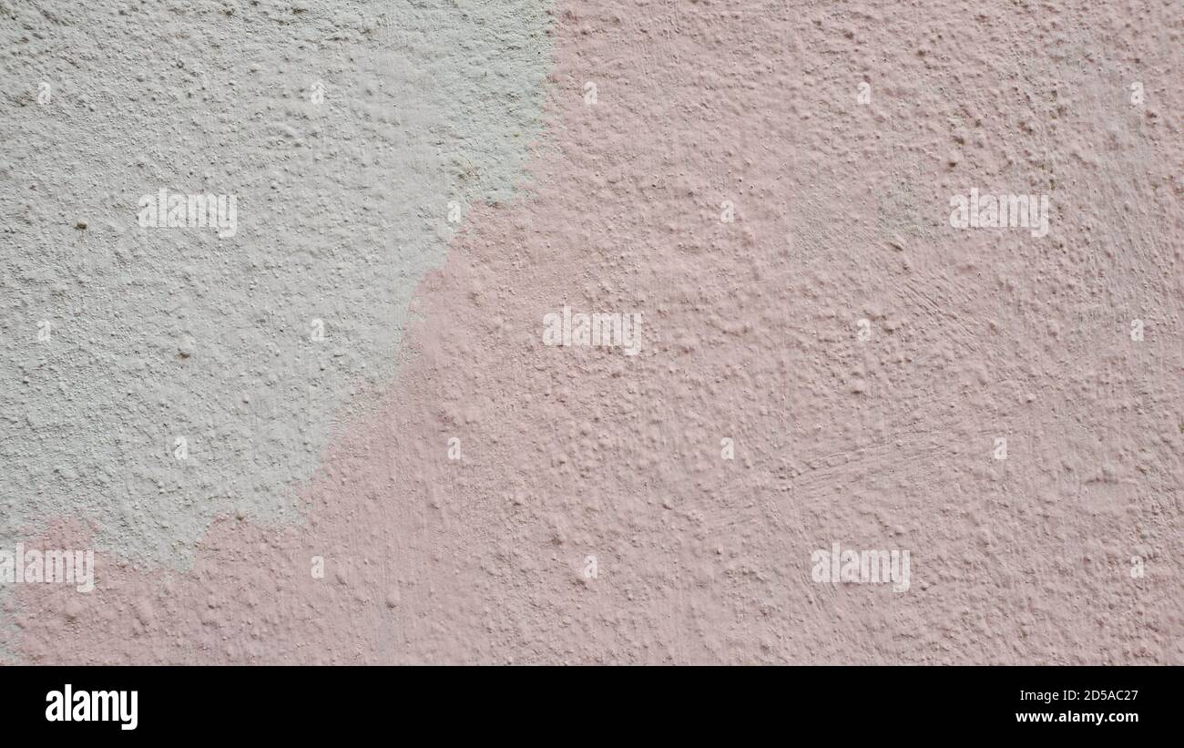 Stained painted wall surface in shades of pink and gray. White spot on ...