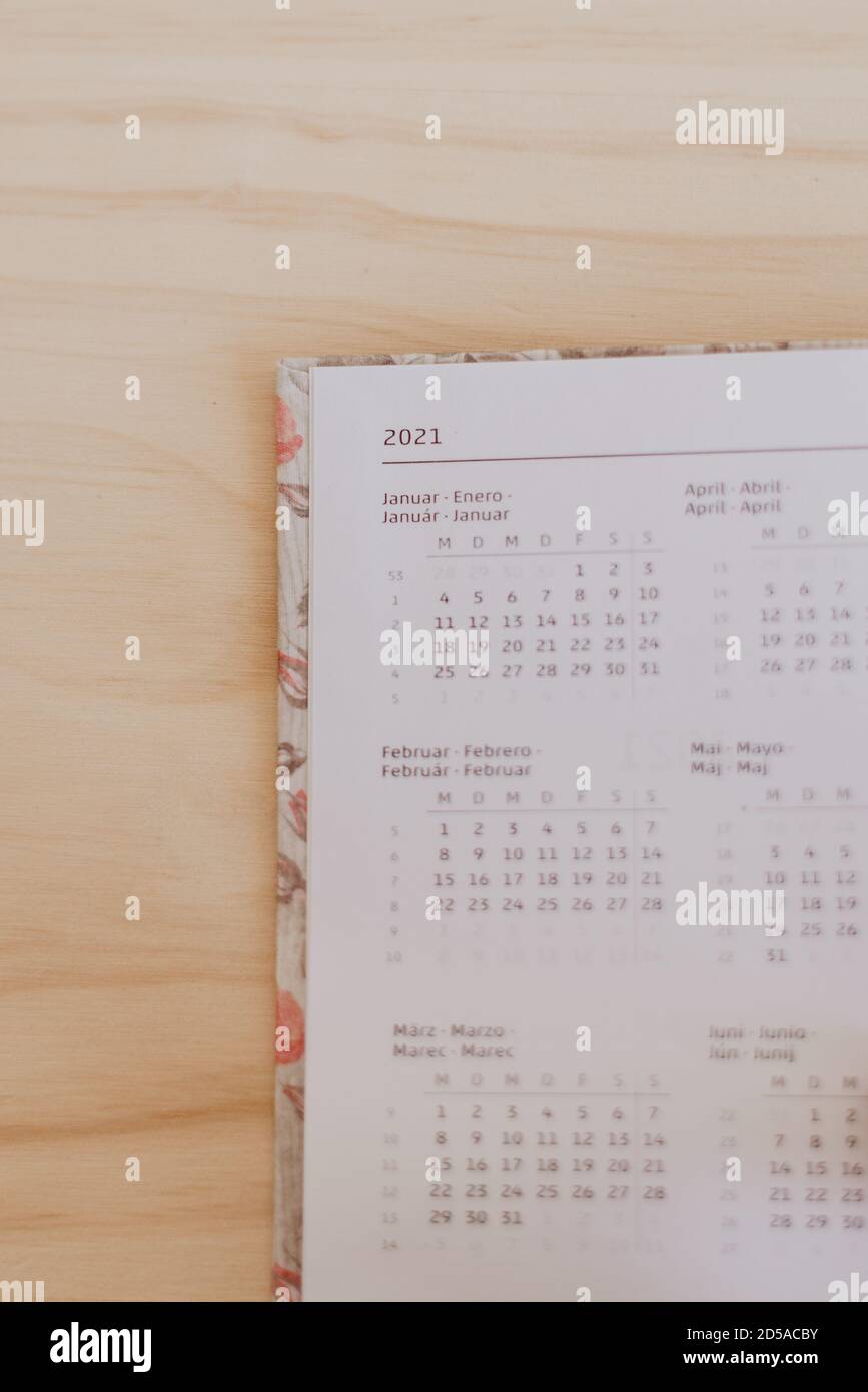 an open planner in the 2021 calendar, is on top of a wooden desk Stock ...