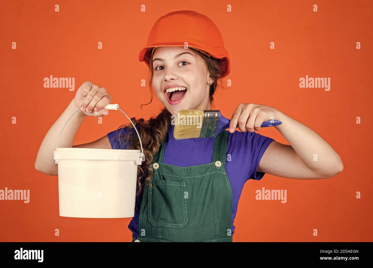 This will be perfect. Happy girl in safety helmet holding painting ...