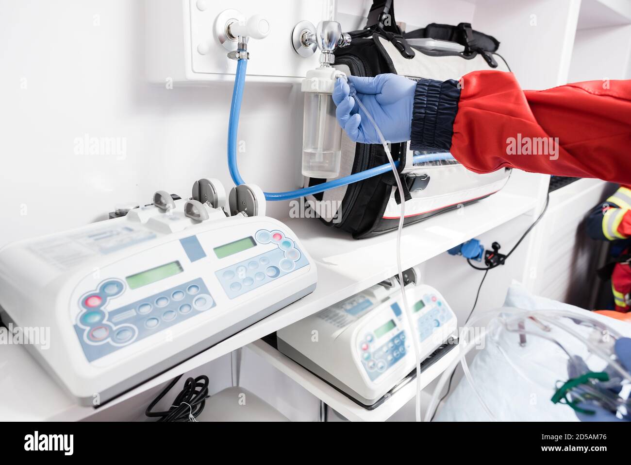 Cropped view of paramedic holding tube of nebuliser in ambulance car ...