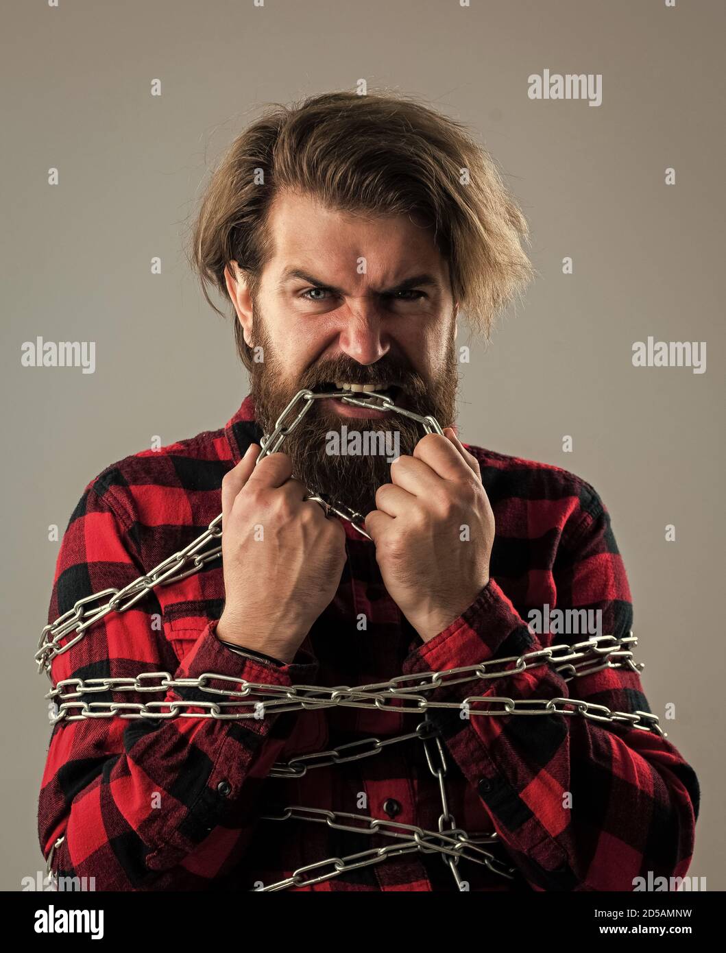 I want to be free. healthy teeth. brutal man with chain. chained up in ...