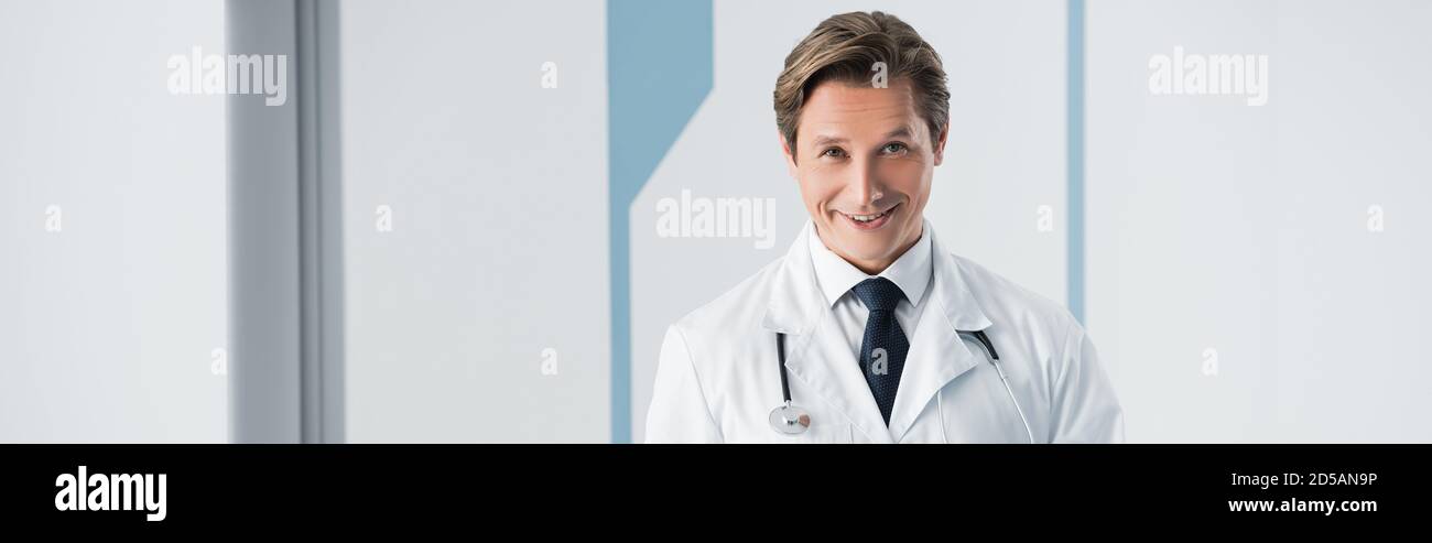 Panoramic orientation of doctor with stethoscope looking at camera in ...