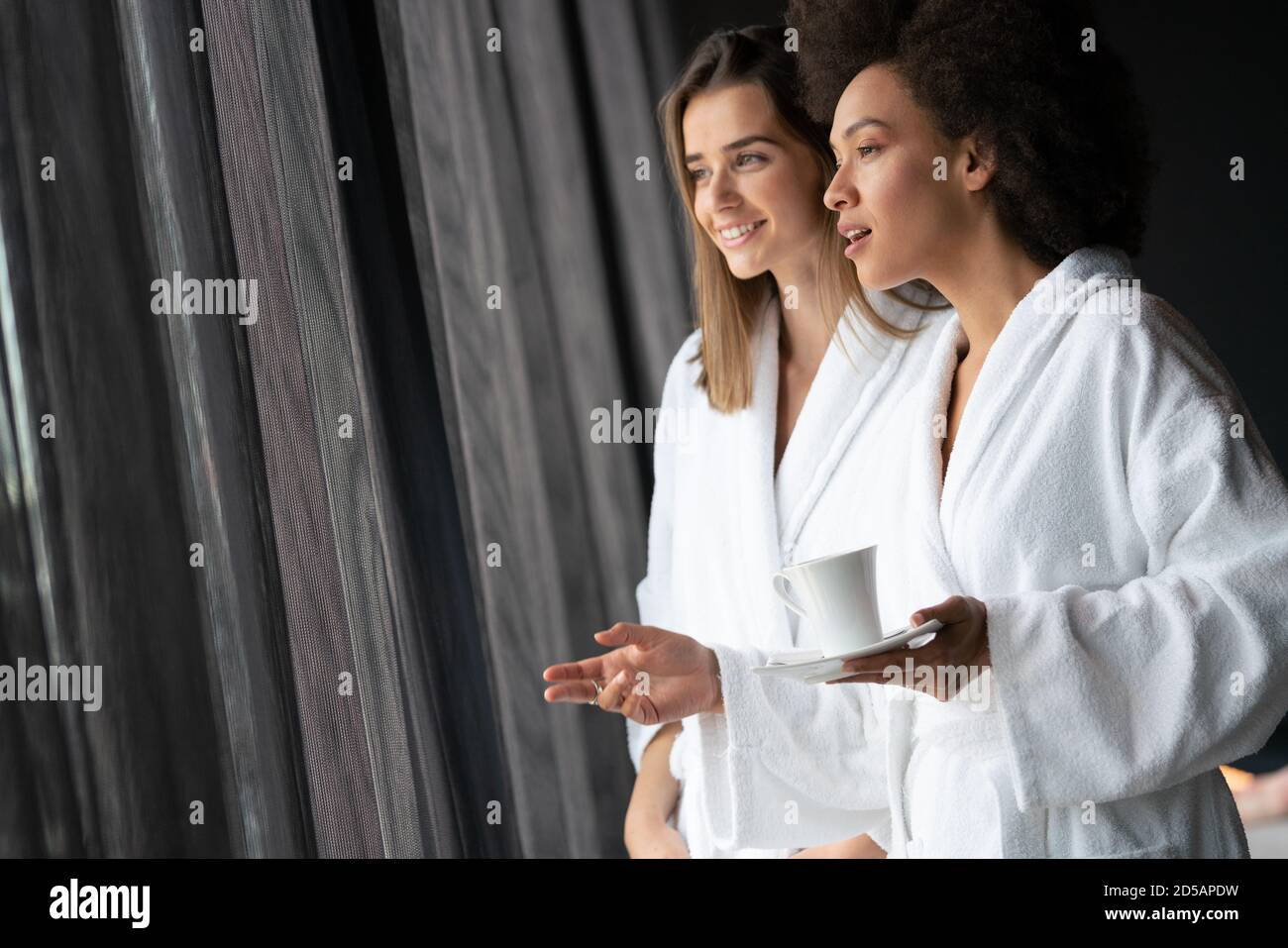 Attractive happy young women drinking coffee at spa center Stock Photo ...