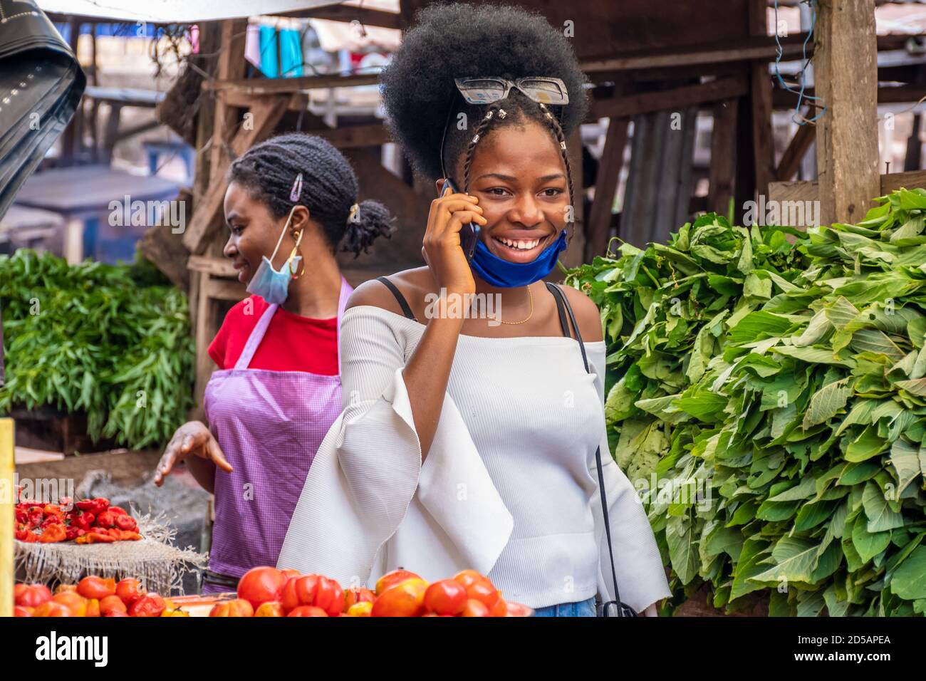 African woman making a phone call in a market Stock Photo - Alamy