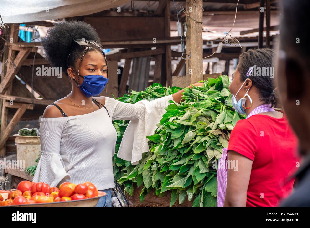 African woman shopping for vegetable in a local market Stock Photo - Alamy