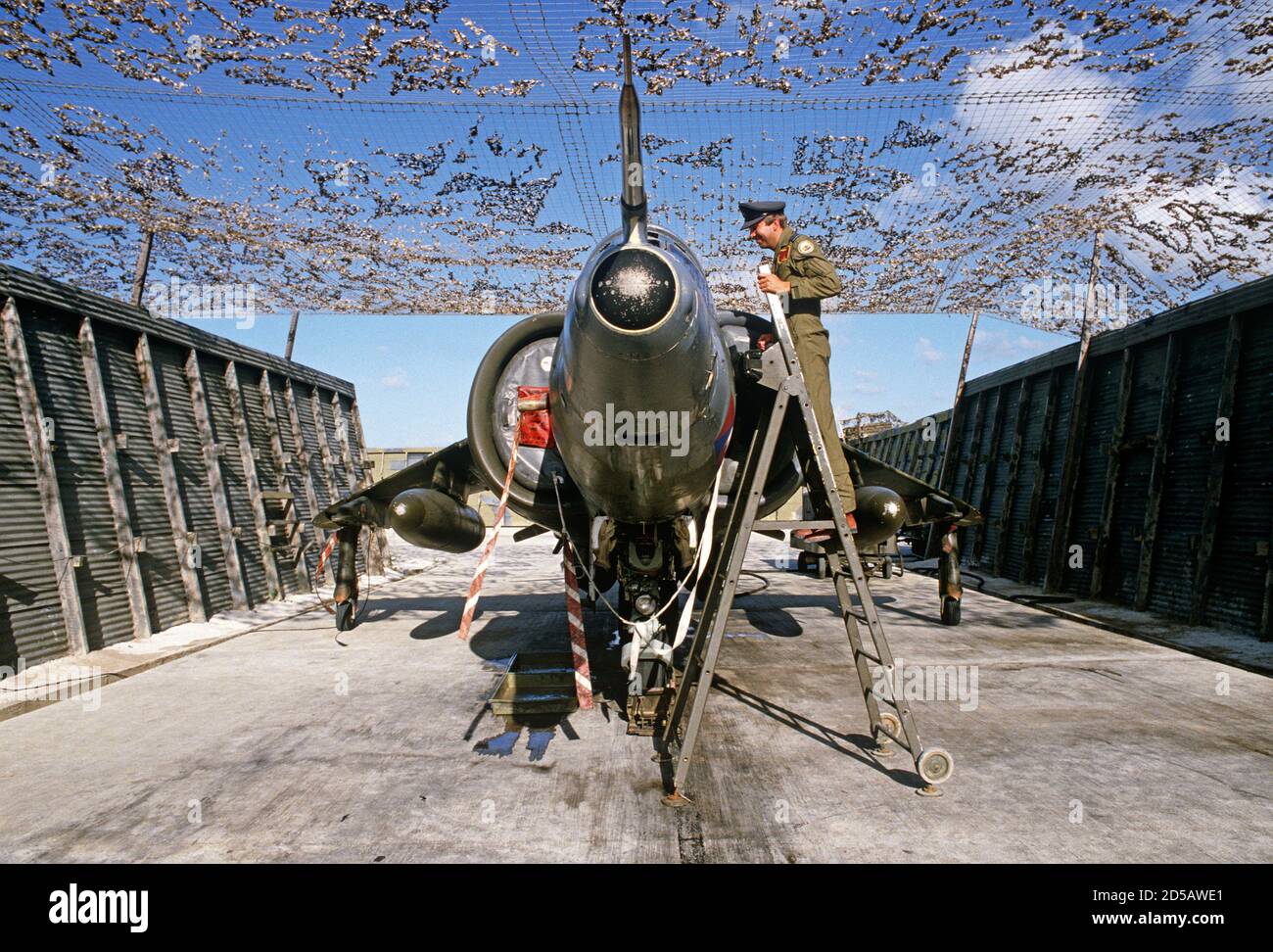 British Royal Air Force Harrier pilot inspecting Harrier Jump jet at ...