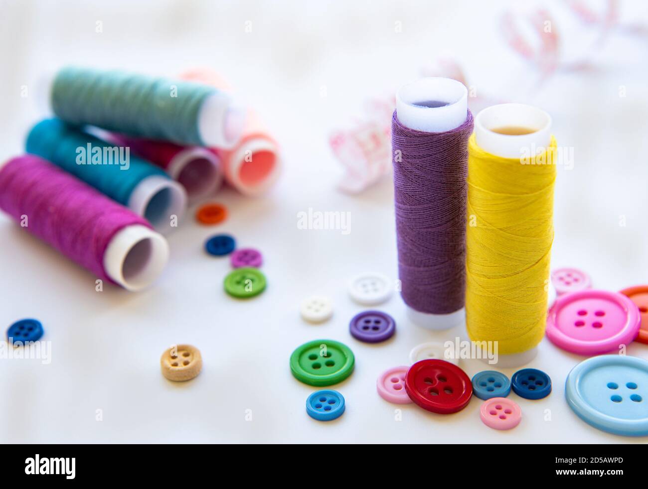 Color threads and sewing accessories on white background Stock Photo ...