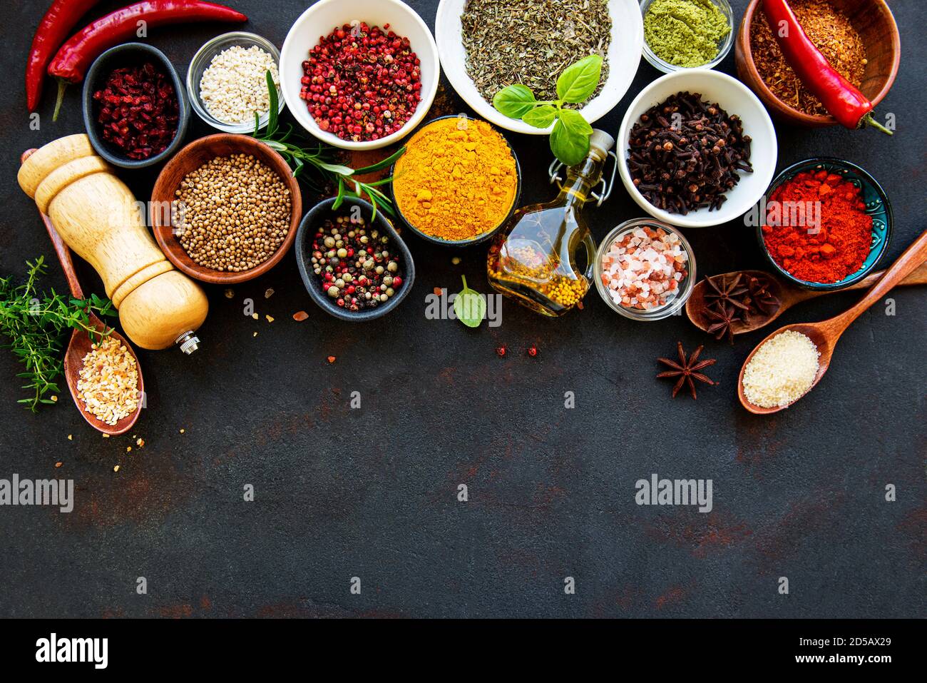 Different assortment of spices on black stone background. Top view ...