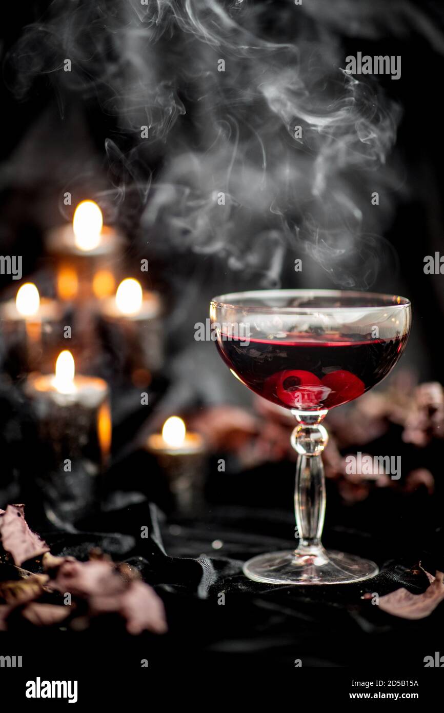 Red gothic Halloween drink with candy eyeballs and candles Stock Photo ...