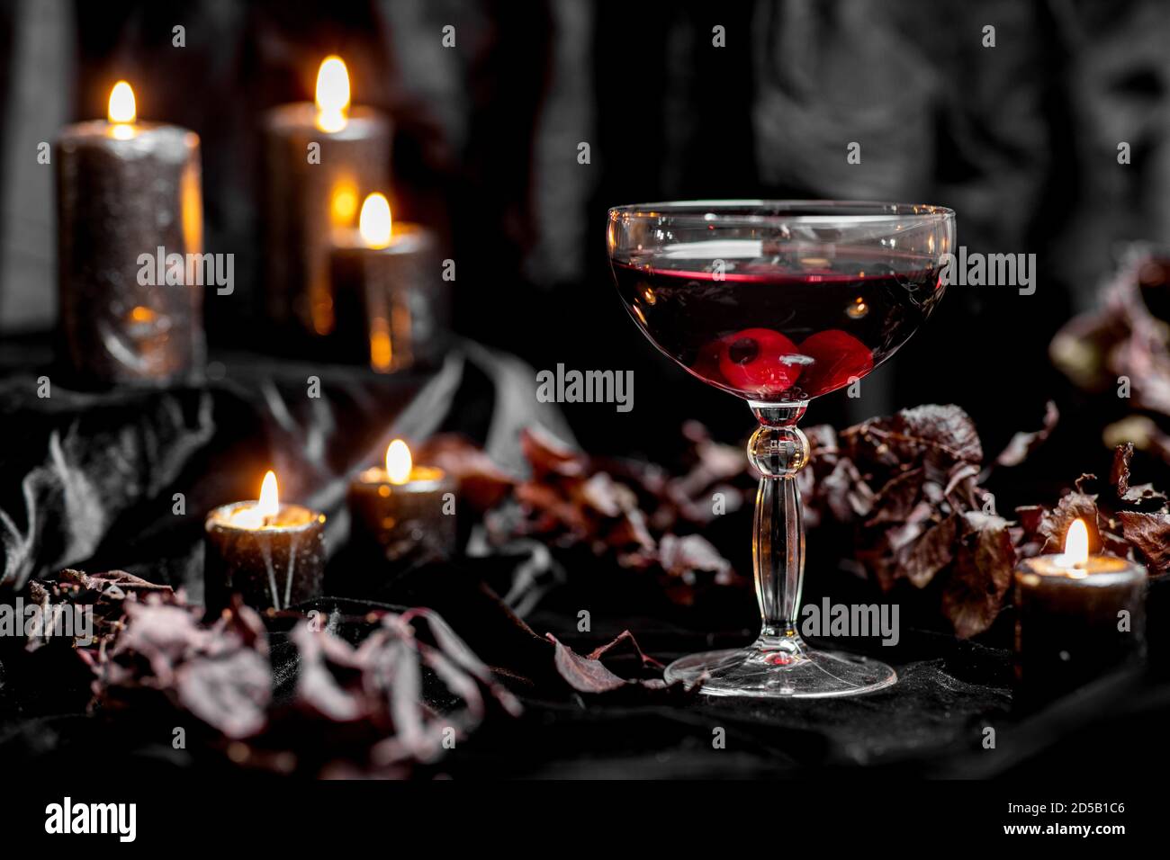 Red gothic Halloween drink with candy eyeballs and candles Stock Photo ...
