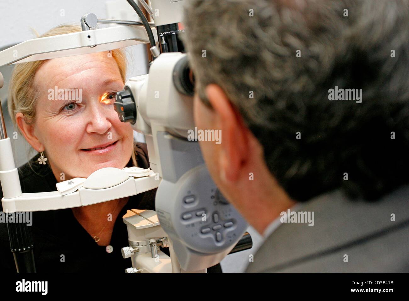 Eye examination using a refraction unit carried out by an optician ...