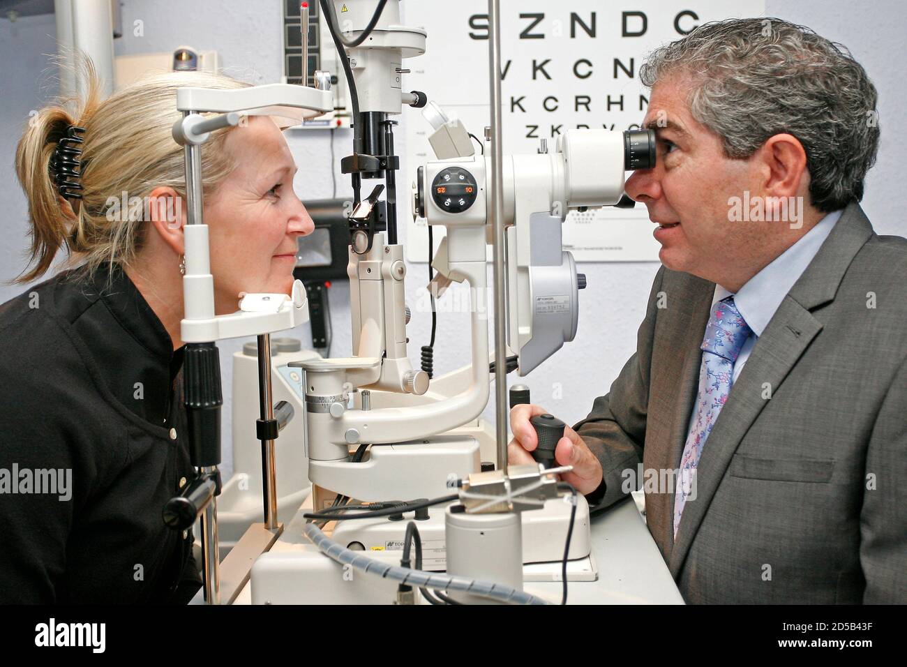 Eye examination using a refraction unit carried out by an optician ...