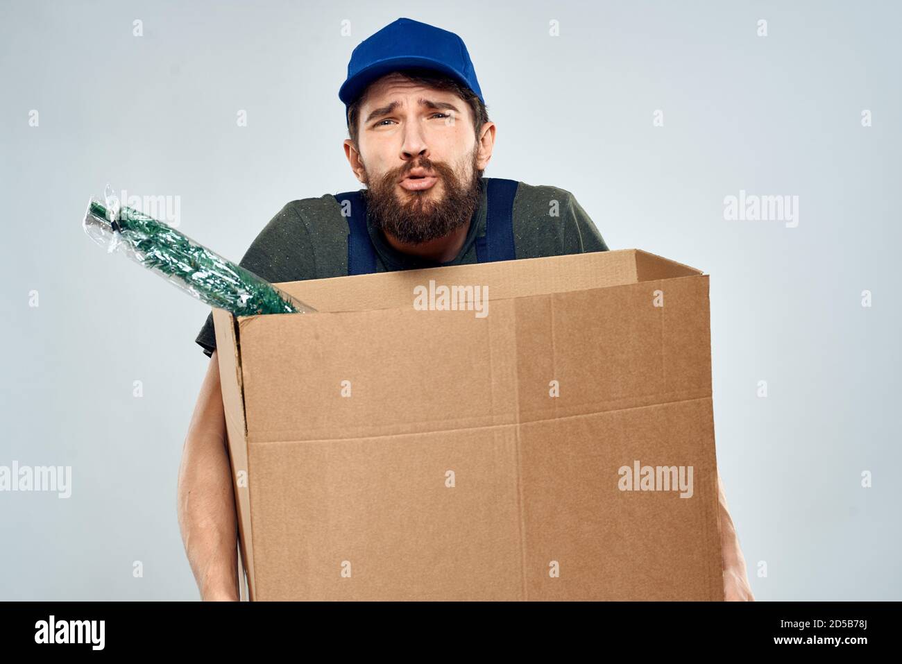 Male worker loading delivery boxes in hands packing lifestyle Stock ...
