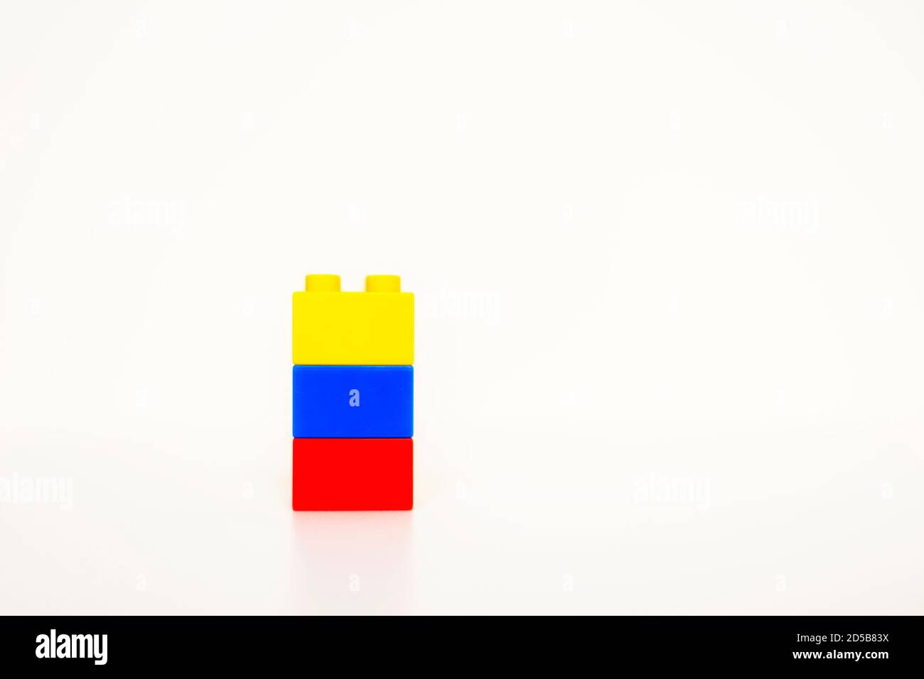Primary colors. Stack of three red, yellow and blue building blocks ...
