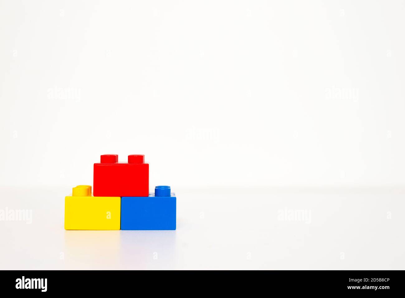 Red, yellow and blue building blocks. Isolated on white background ...