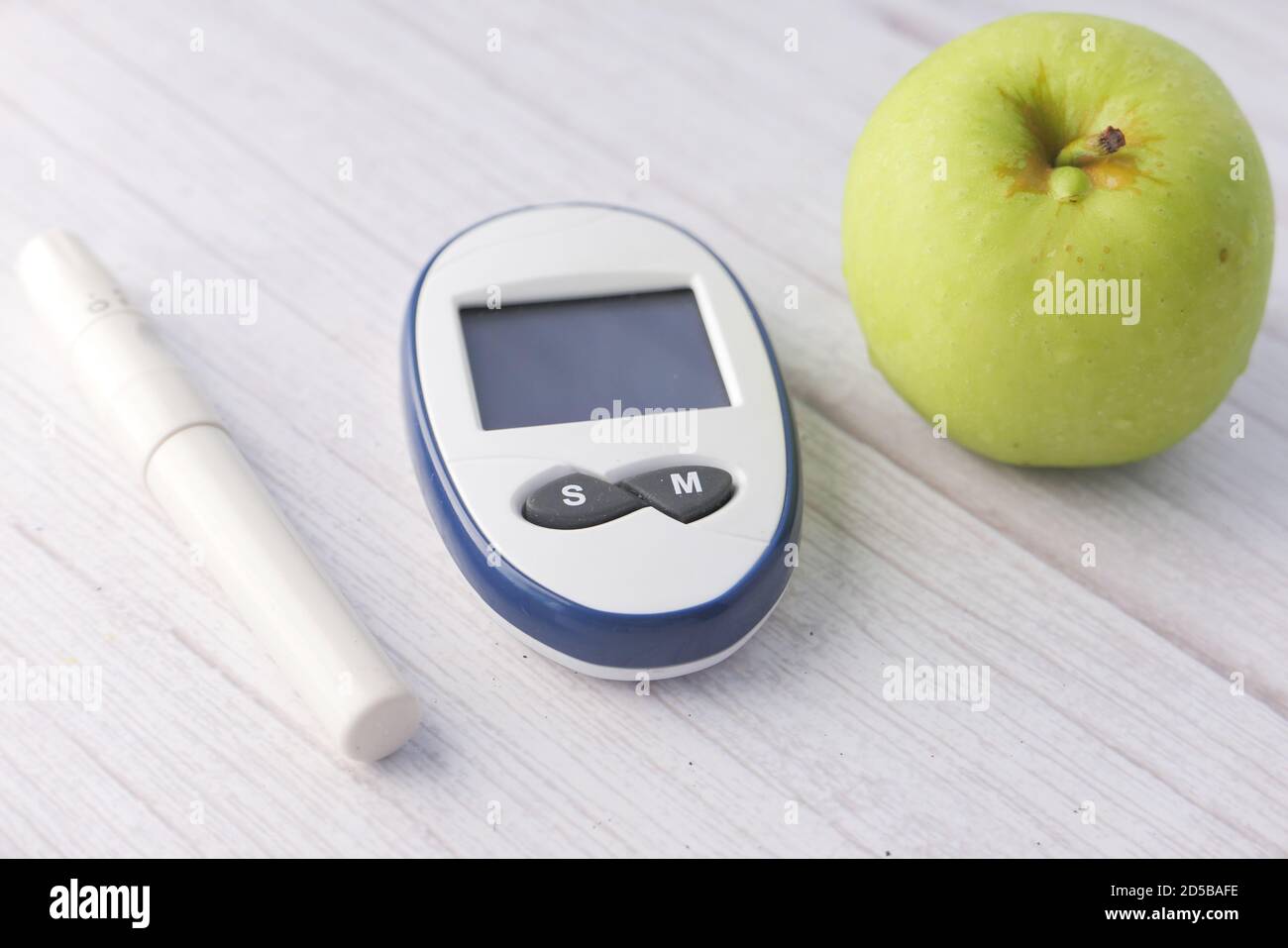 diabetic measurement tools, apple on table Stock Photo - Alamy