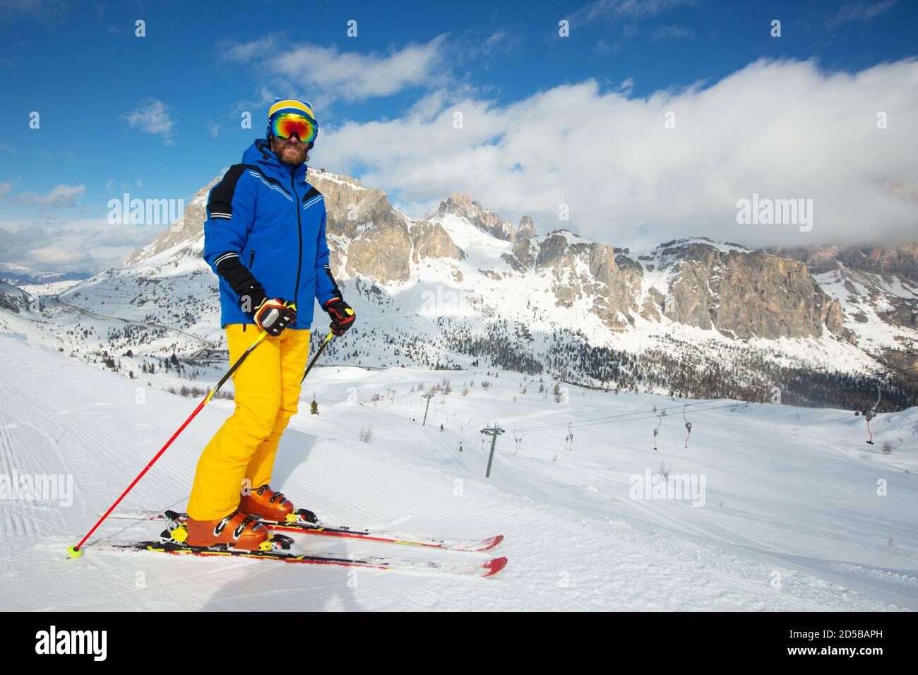 Alpine skier stand on slope in winter mountains Dolomites Italy in ...