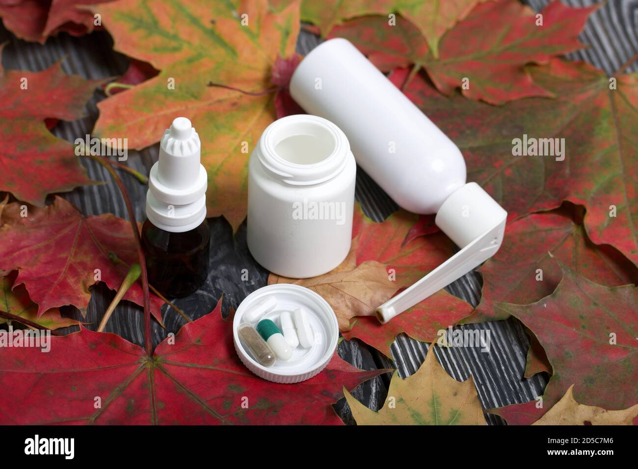 Pill container, inhaler and nasal drops. The lid of the container and ...