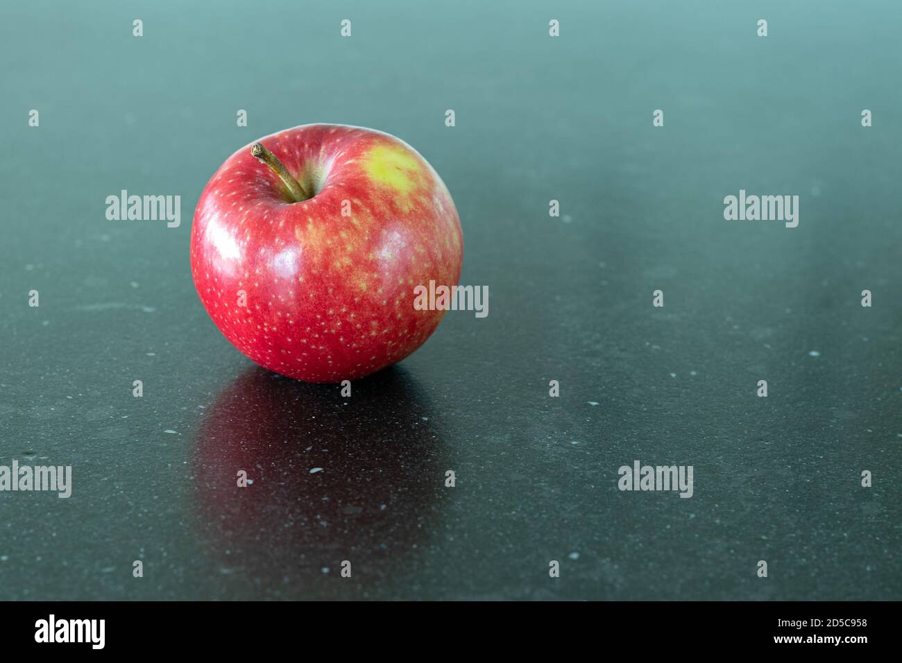 One apple a day keeps the doctor away. A red tasty and shinny apple on ...