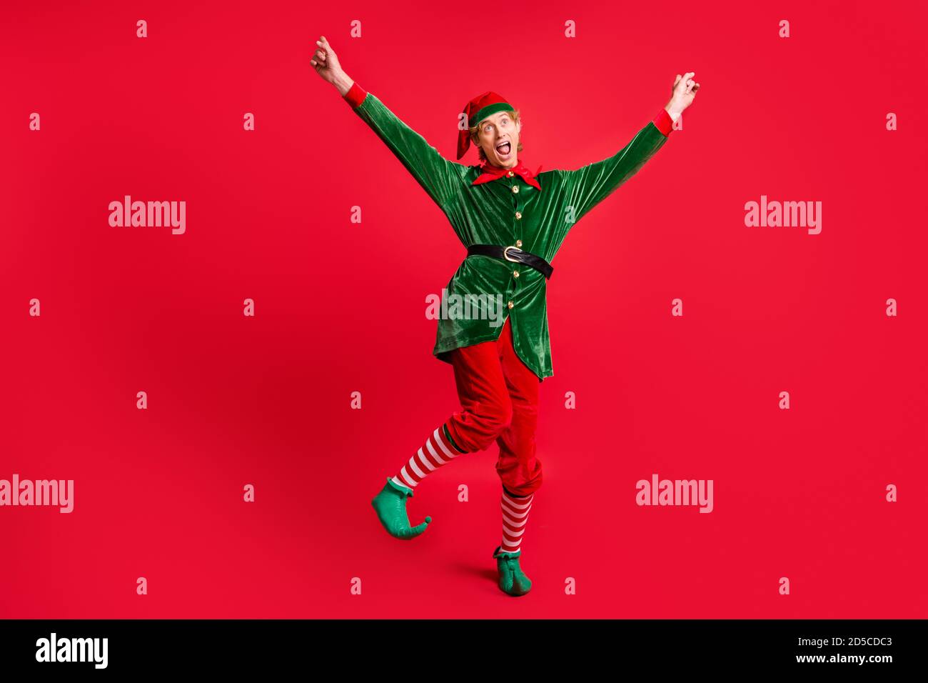 Full size photo of crazy elf dancing with raised fists wear costume ...