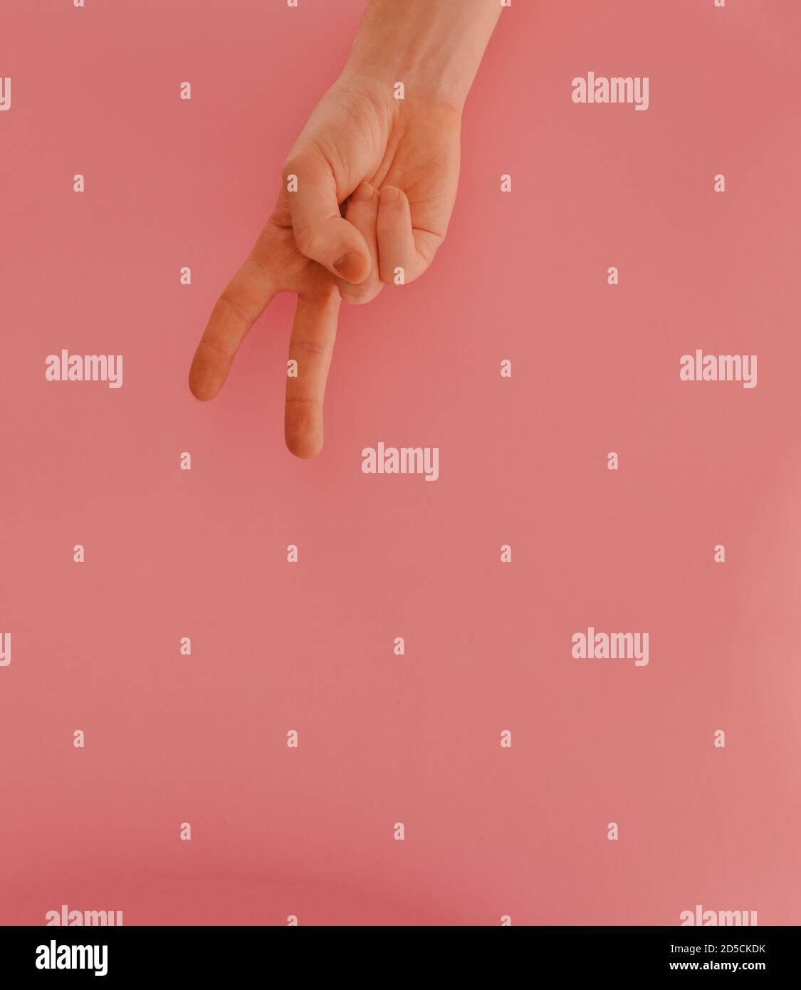 Vertical shot of a hand showing the peace sign Stock Photo - Alamy