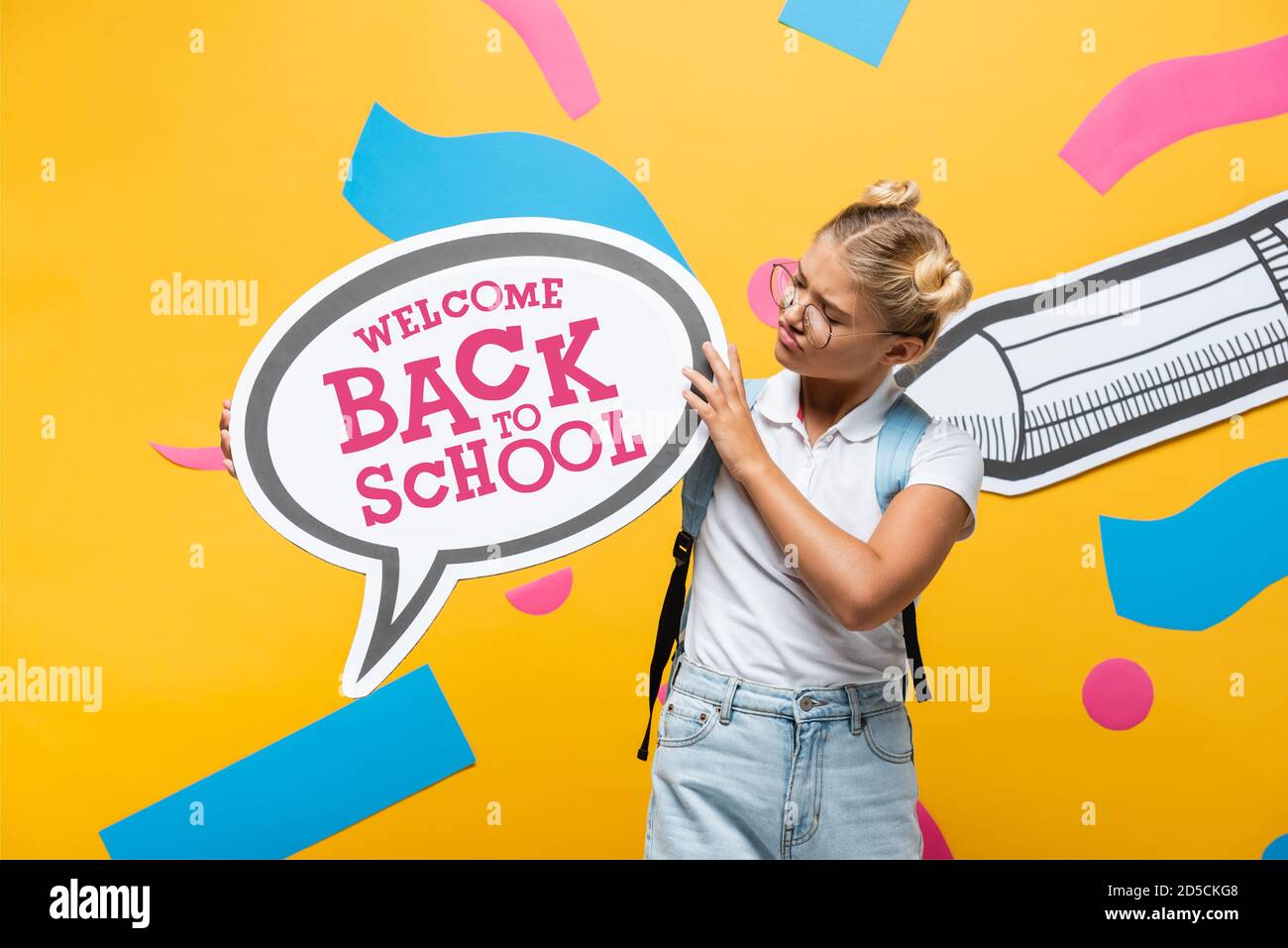 skeptical schoolgirl holding speech bubble with welcome back to school ...