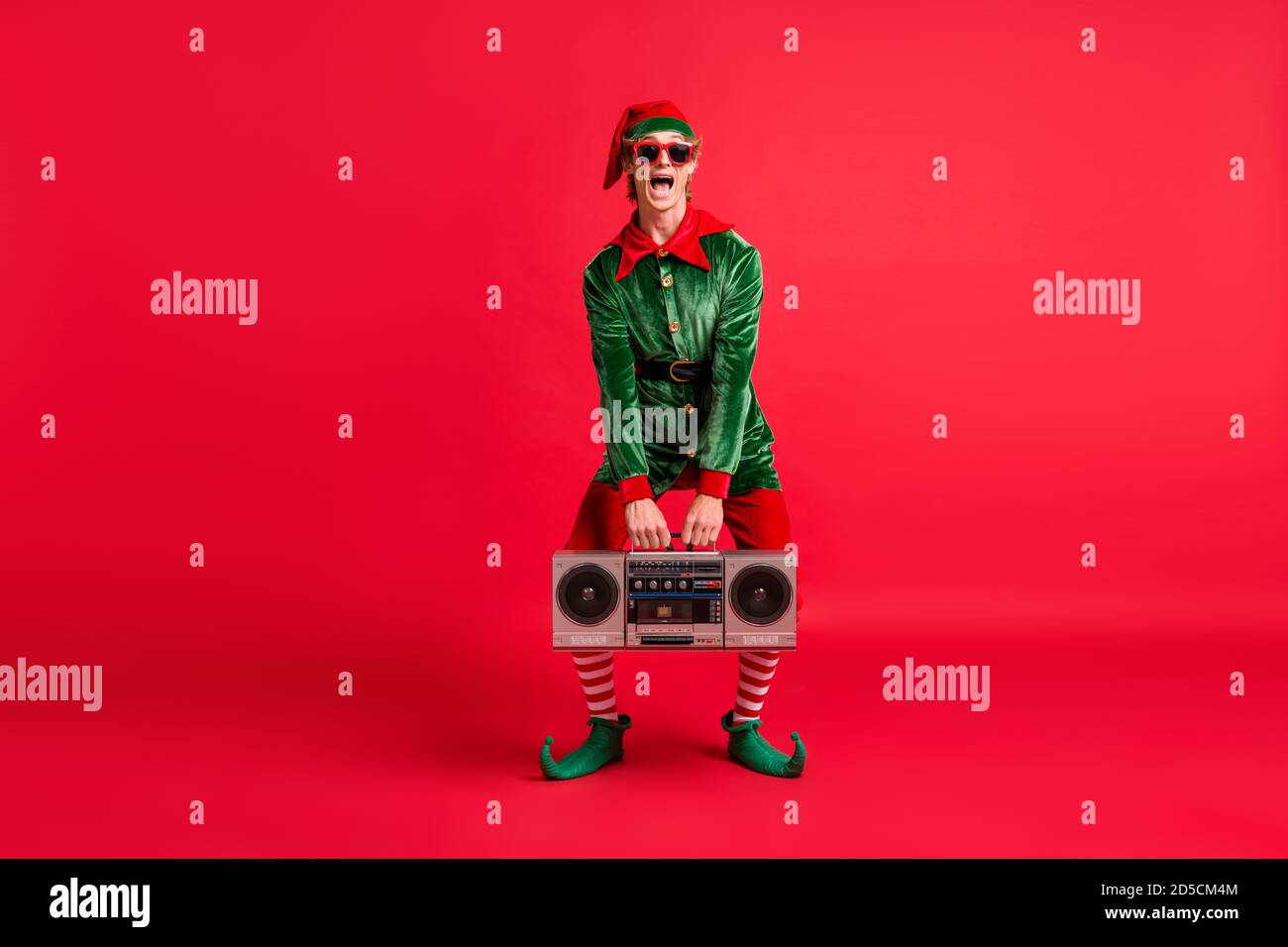 Full body photo of crazy elf hold boom box on x-mas christmas party ...