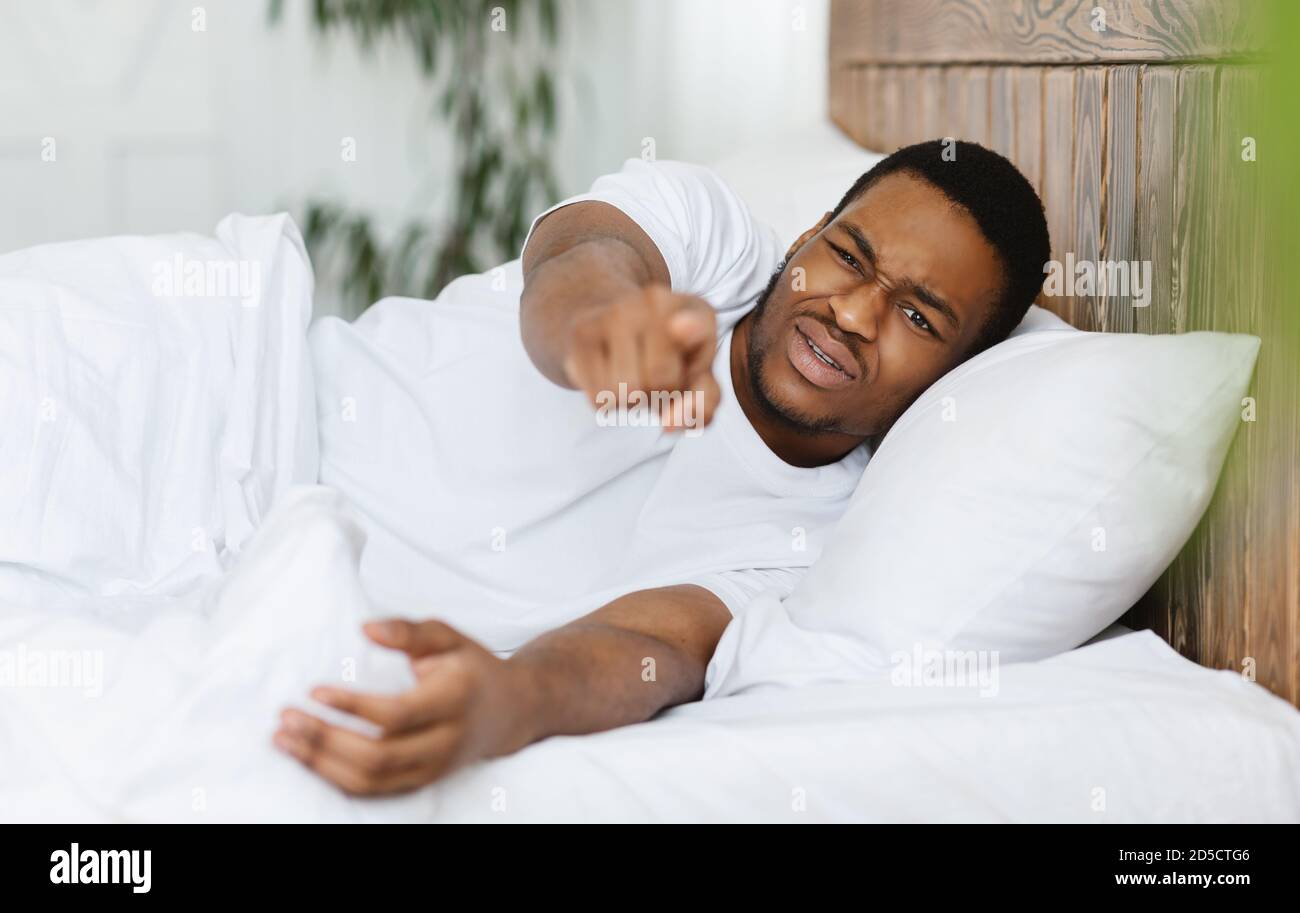 Disturbed Sleepy Man Pointing Finger At Camera Lying In Bedroom Stock ...
