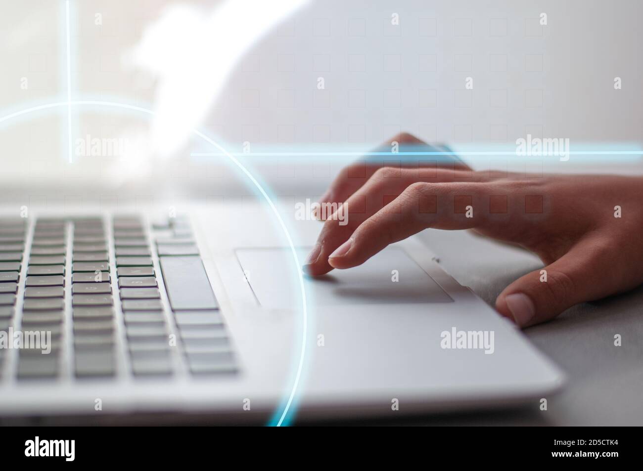 hand on trackpad ,light background with digital overlay.working at home ...