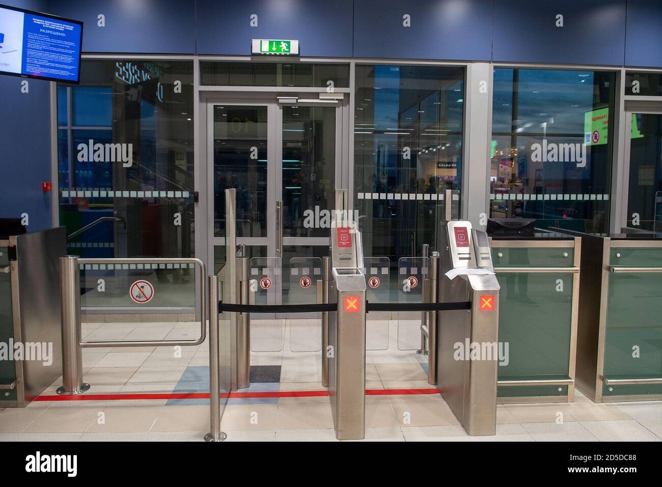 Modern airport departure check in gates closed with red X signs above ...