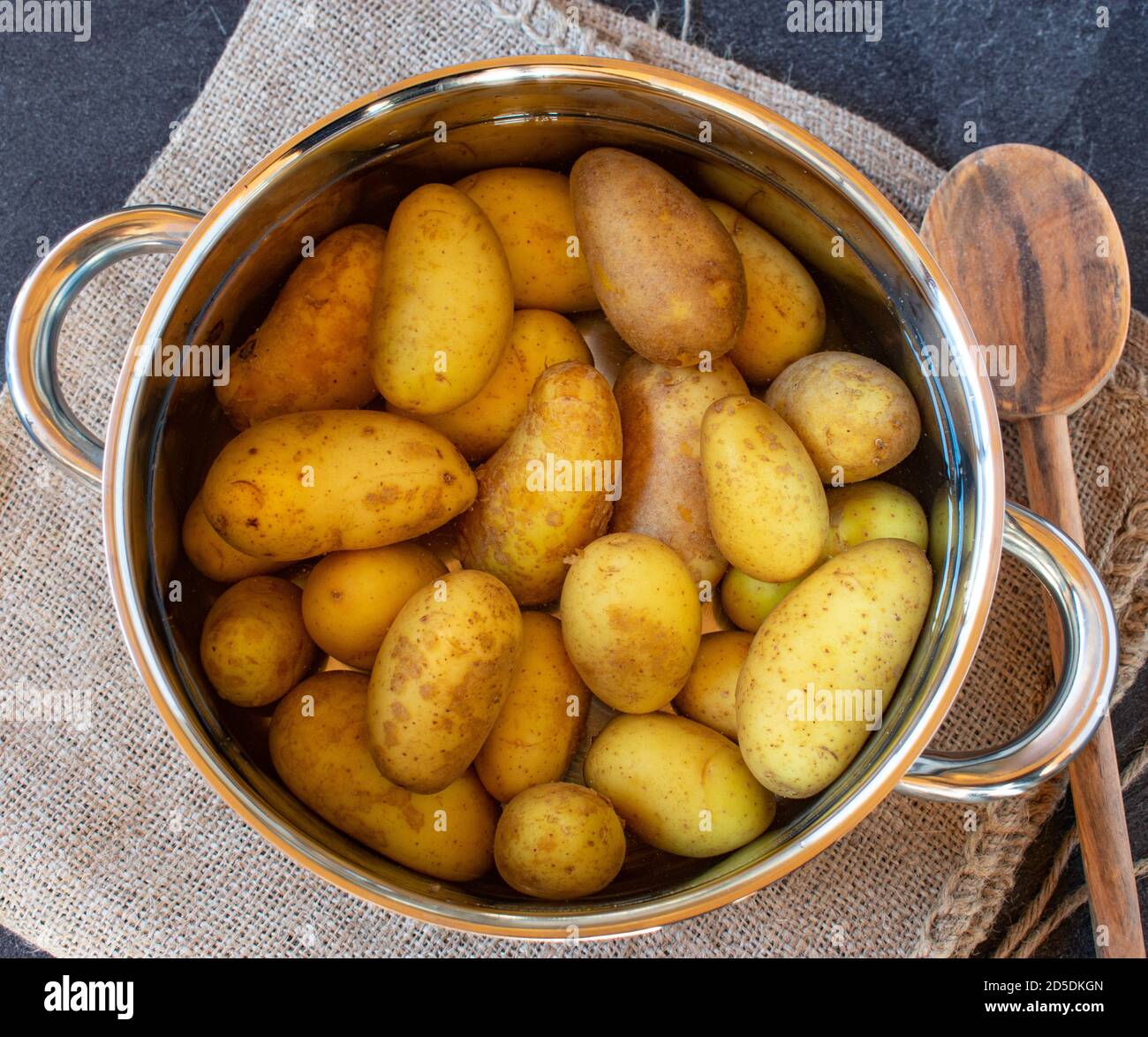 raw and uncooked potatoes in a pot with water from above Stock Photo ...