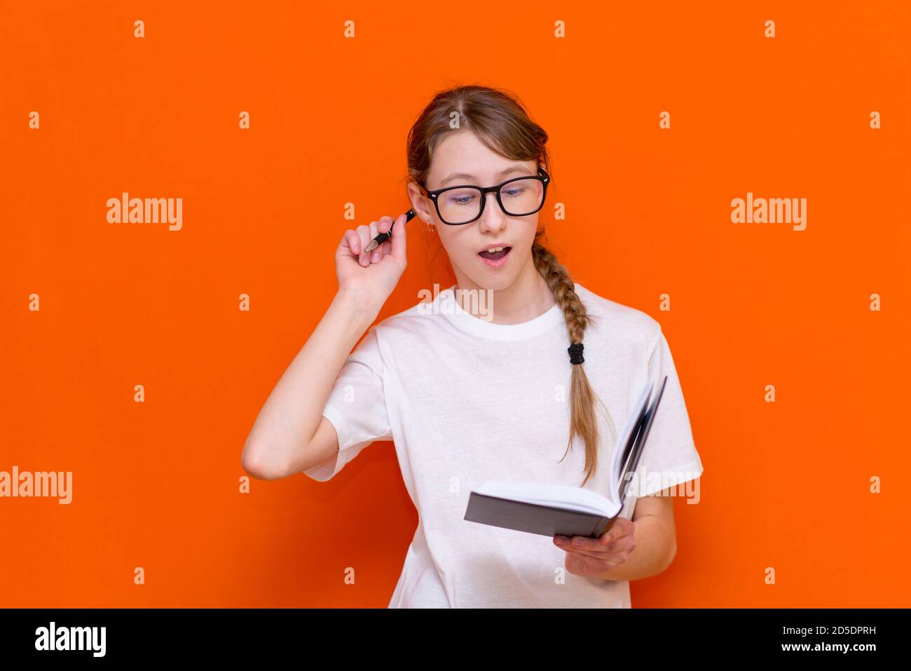 Excited thinking looking at camera young girl in eyeglasses, white T ...
