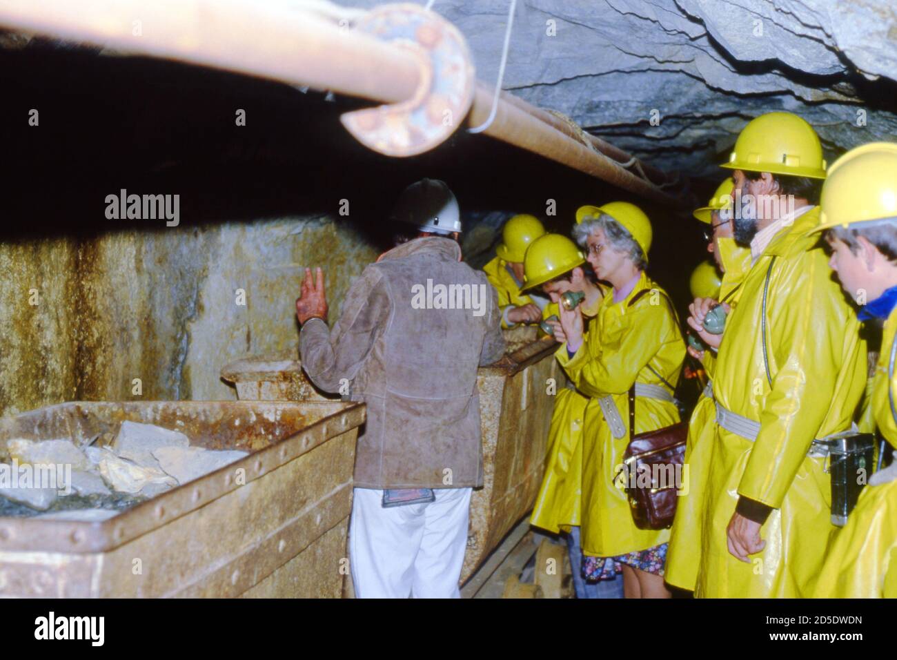 Guide explaining the workings of the mine to visitors underground at ...